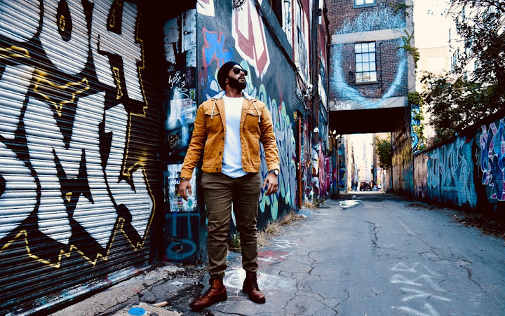 Free: Man Standing Beside Building With Murals - nohat.cc