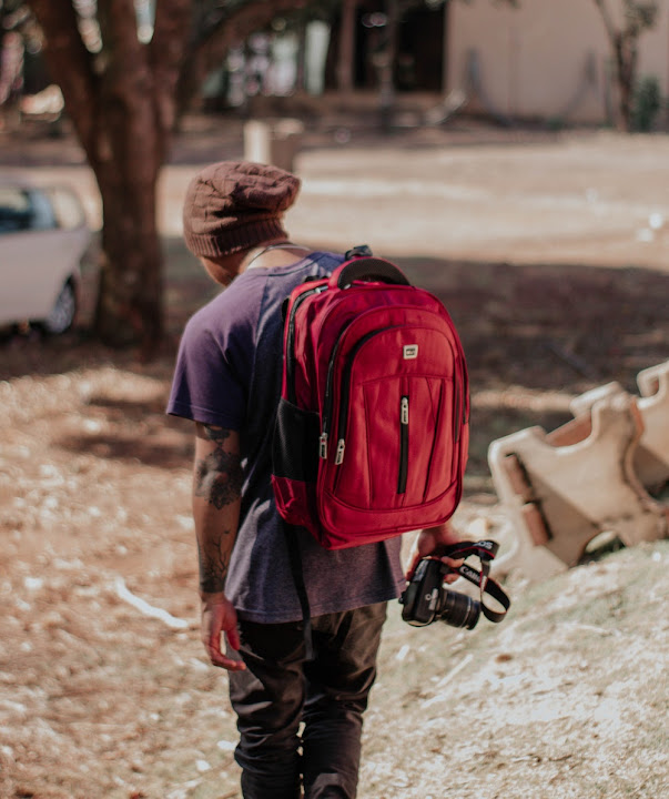 Free: Man Holding Camera Using Red Backpack - nohat.cc