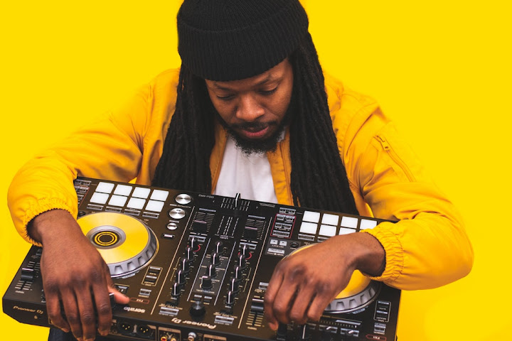Free: Man Holding Dj Controller on Yellow Background - nohat.cc