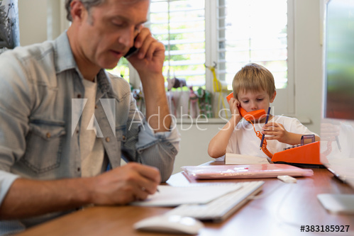 Free: Cute son imitating father on telephone in home office - nohat.cc