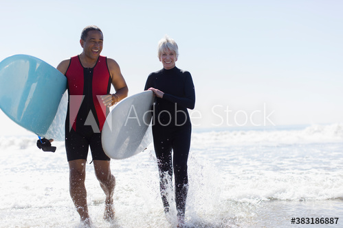 Free: Happy active senior couple with surfboards running in ocean surf ...