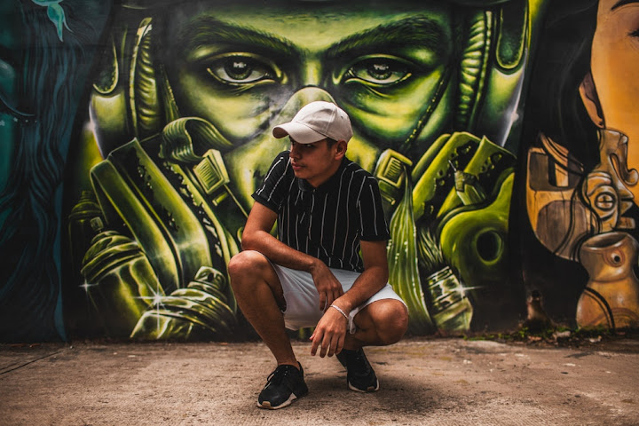 Free: Photo of Man Squat Posing In Front of Graffiti Wall - nohat.cc