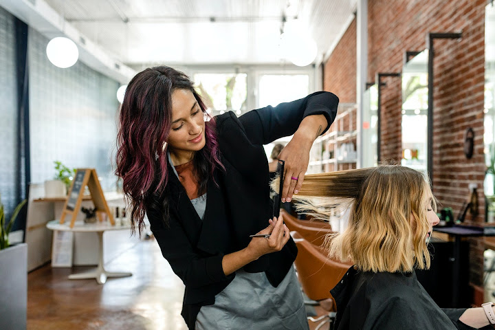 Free: Hairstylist trimming hair of the customer in… | Free stock photo ...